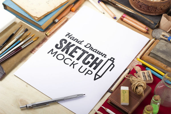 Hand Drawn Sketch Mockup with a Man Drawing - Mockup Hunt