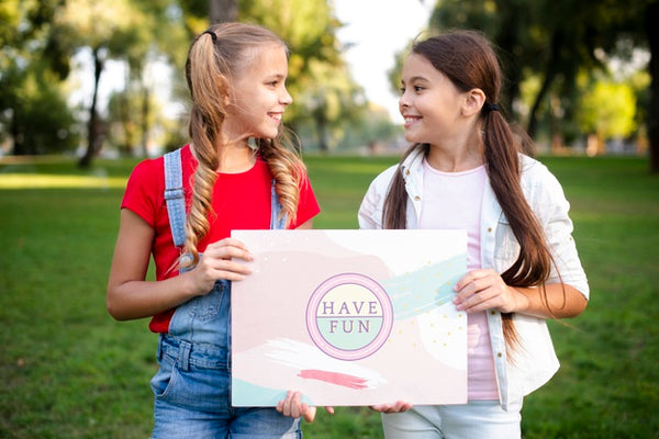 Girls Holding Together Paper With Motivational Message Psd - Mockup Hunt