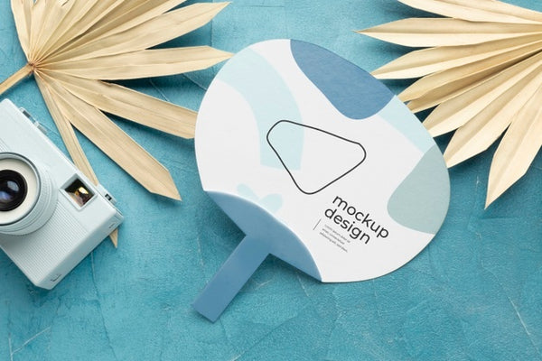 Paper Mock-Up Hand Fan With Dry Leaves And Camera Psd - Mockup Hunt
